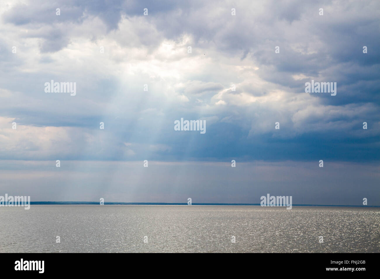 A ray of sun coming out from behind the clouds Stock Photo - Alamy