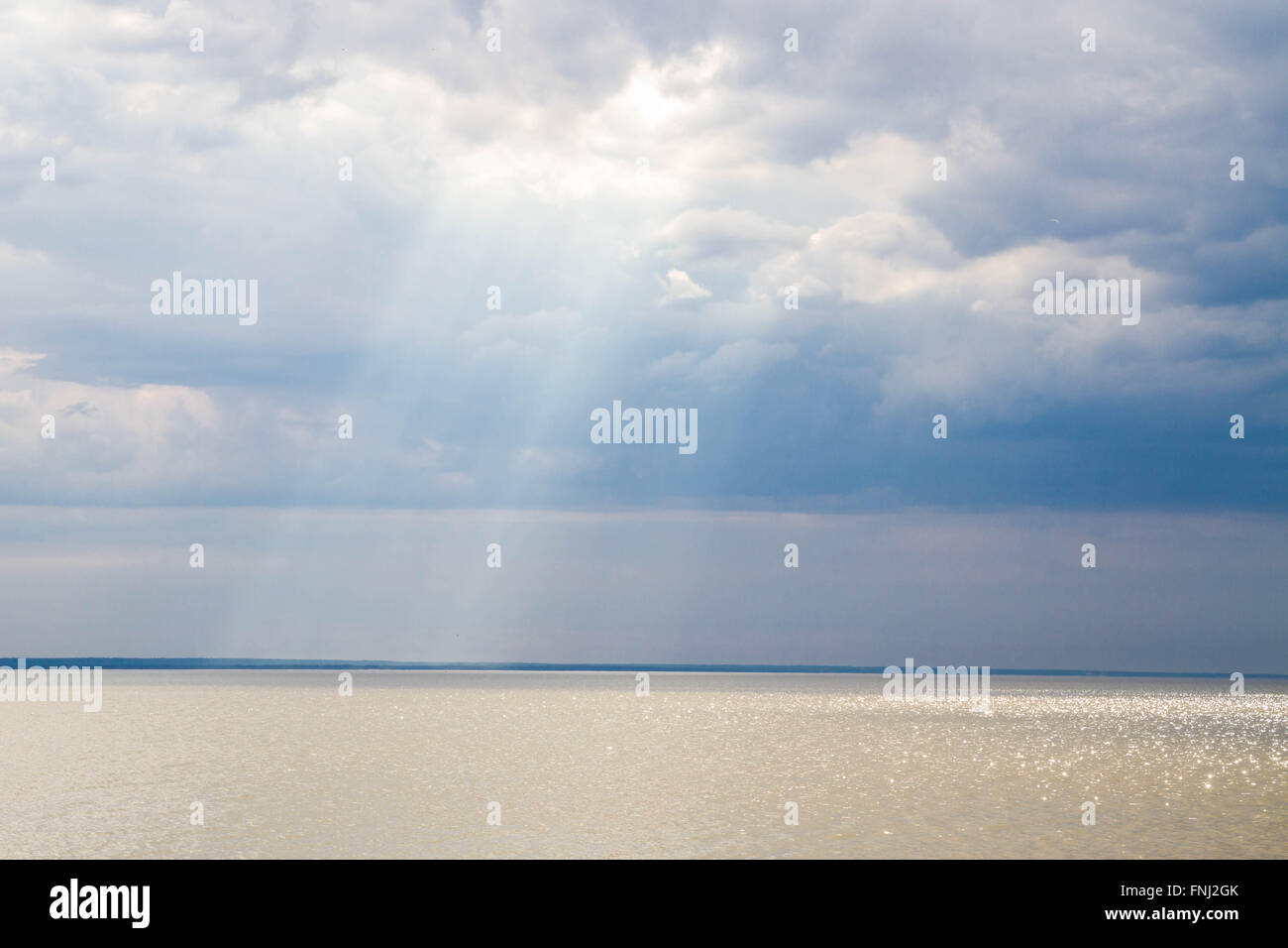 A ray of sun coming out from behind the clouds Stock Photo - Alamy