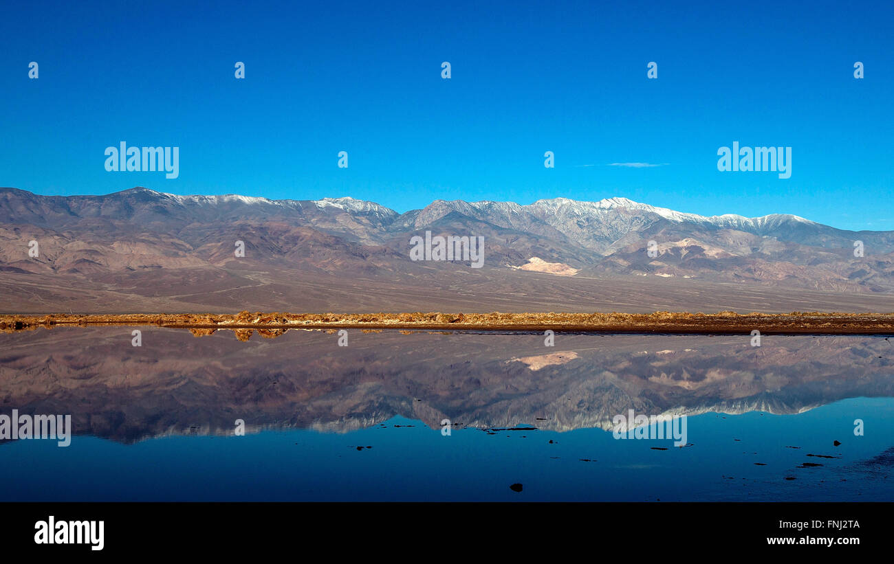 Panamint mountain range reflected in a pond, Death Valley National Park ...