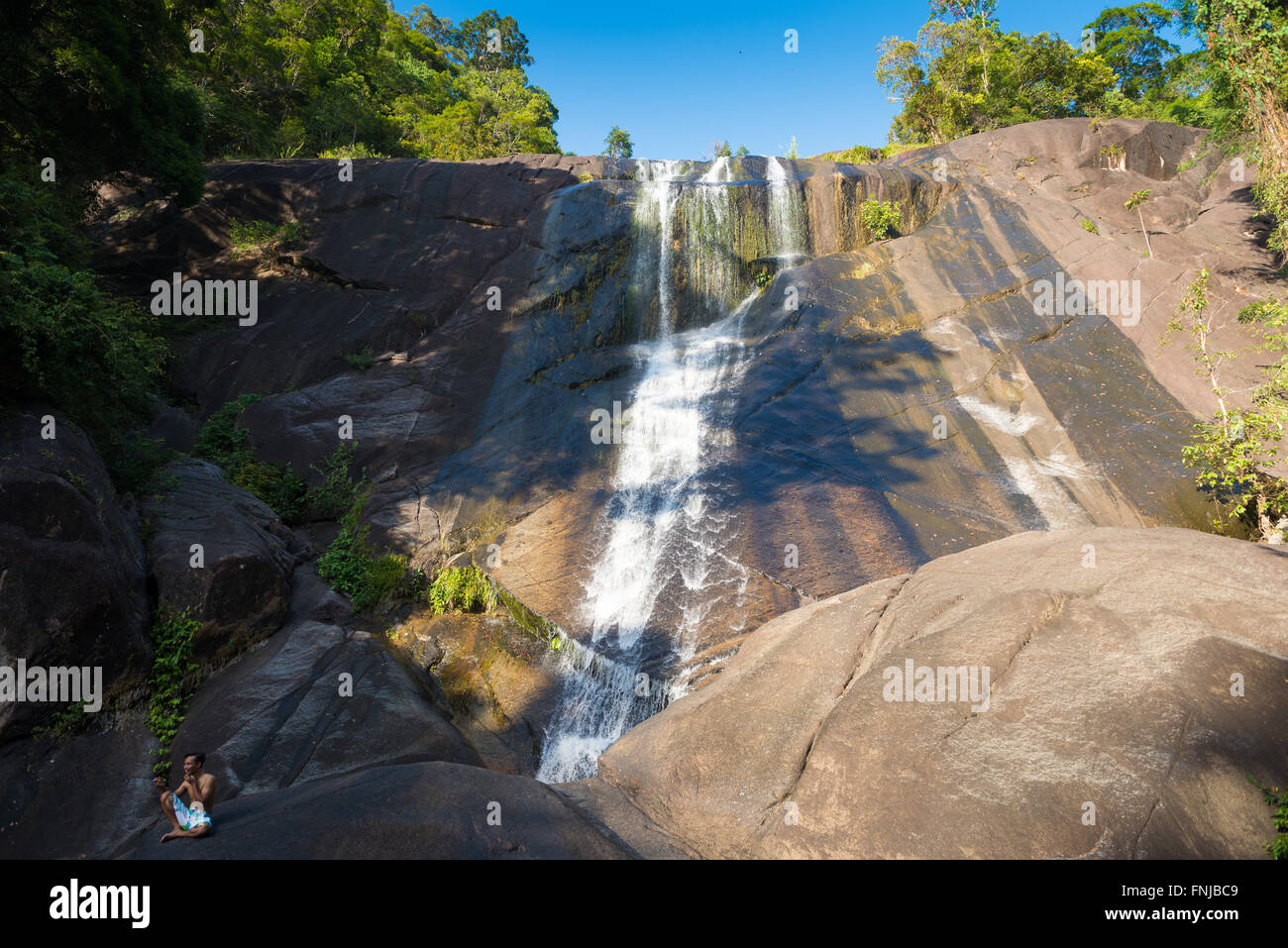 Man on the rocks of Langkawi Telaga Tujuh (Seven Wells) waterfalls ...