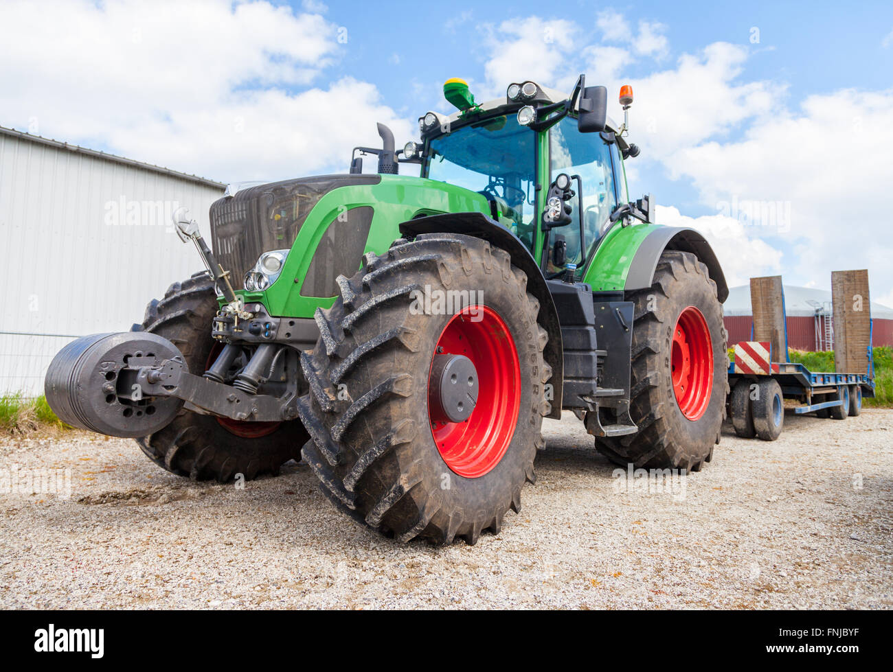 german green tractor with low bed trailer Stock Photo - Alamy