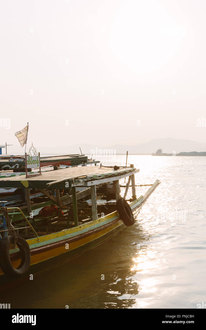 Old Burmese boats anchored at edge of Irrawaddy (Ayerwaddy) River in ...