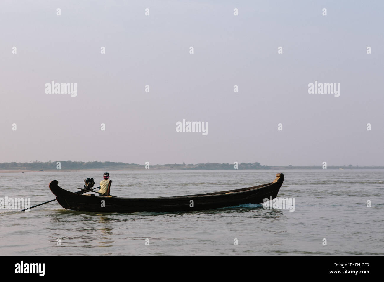 Long fishmerman boat on Ayerwaddy (Irrawaddy) River in Bagan, Myanmar ...