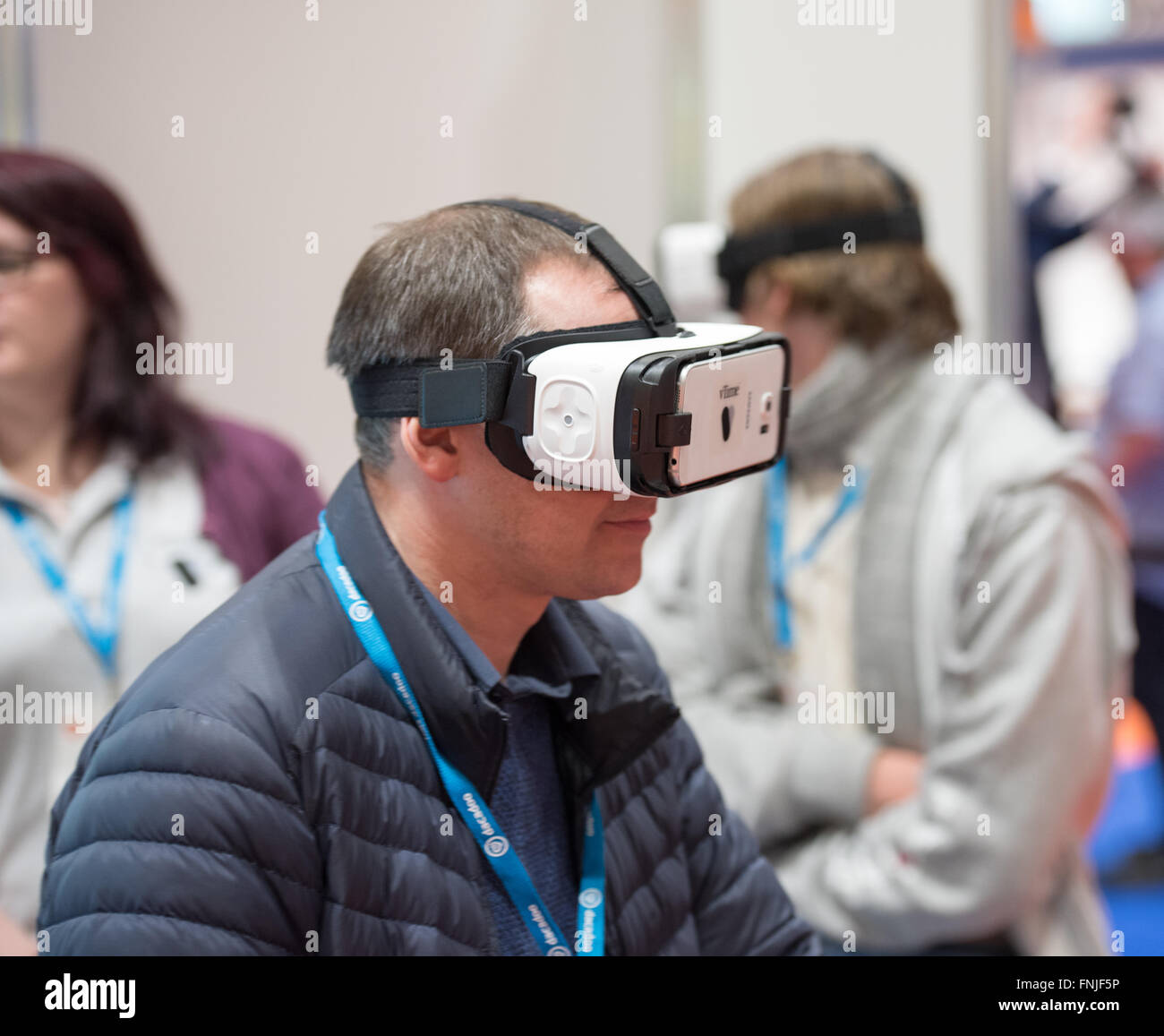 London, UK 15th March 2016, Wearable Technology Show, visitor tries on ...