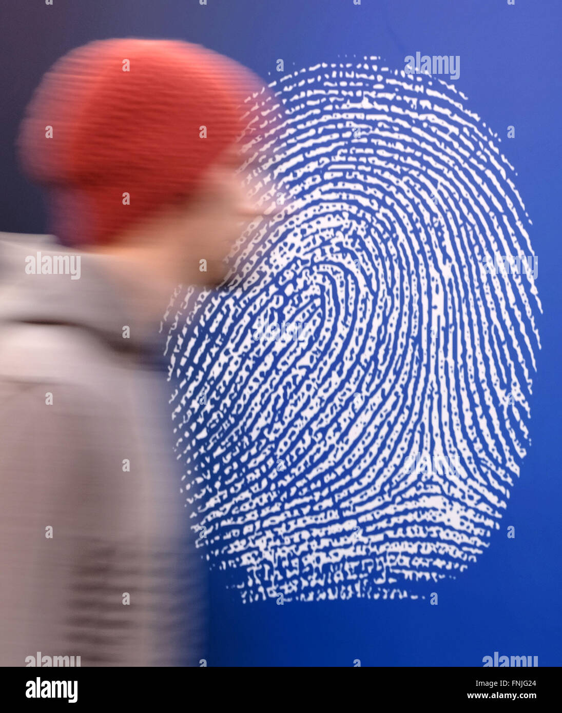 Hanover, Germany. 15th Mar, 2016. A visitor walks past an image ...
