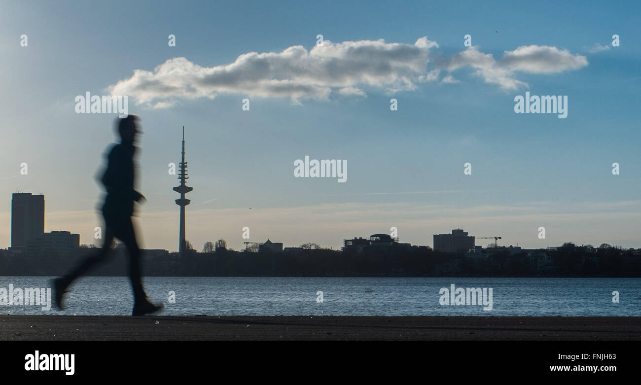 Hamburg, Germany. 15th Mar, 2016. A man jogs along the Alster river in ...