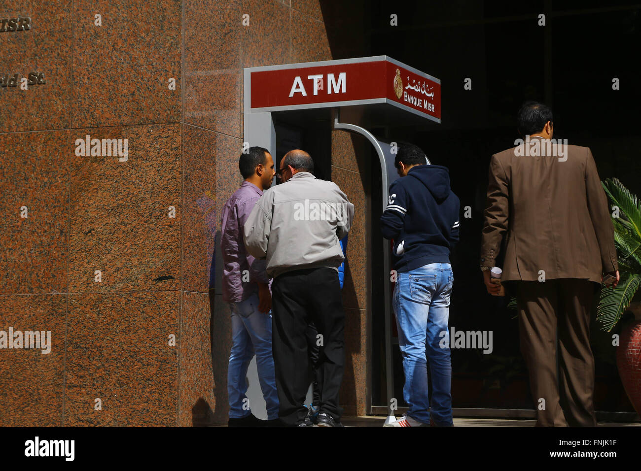 Cairo, Egypt. 15th Mar, 2016. People use an automatic teller machine ...
