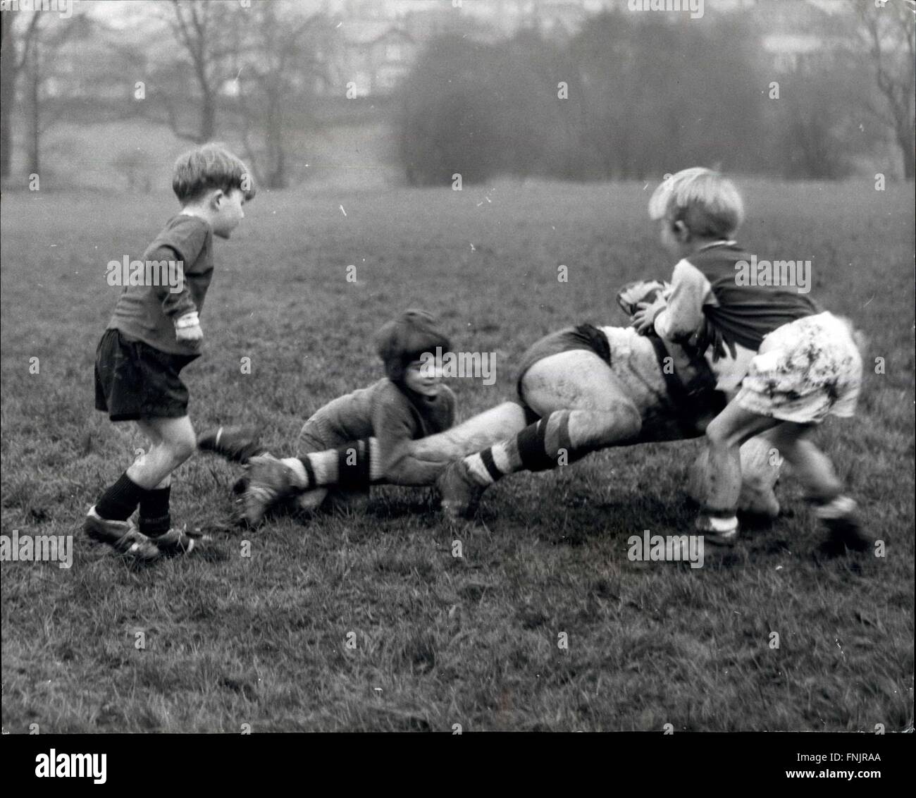 1964 - Huddersfield R.U.F.C. full-back Peter Fitton goes down to three ...