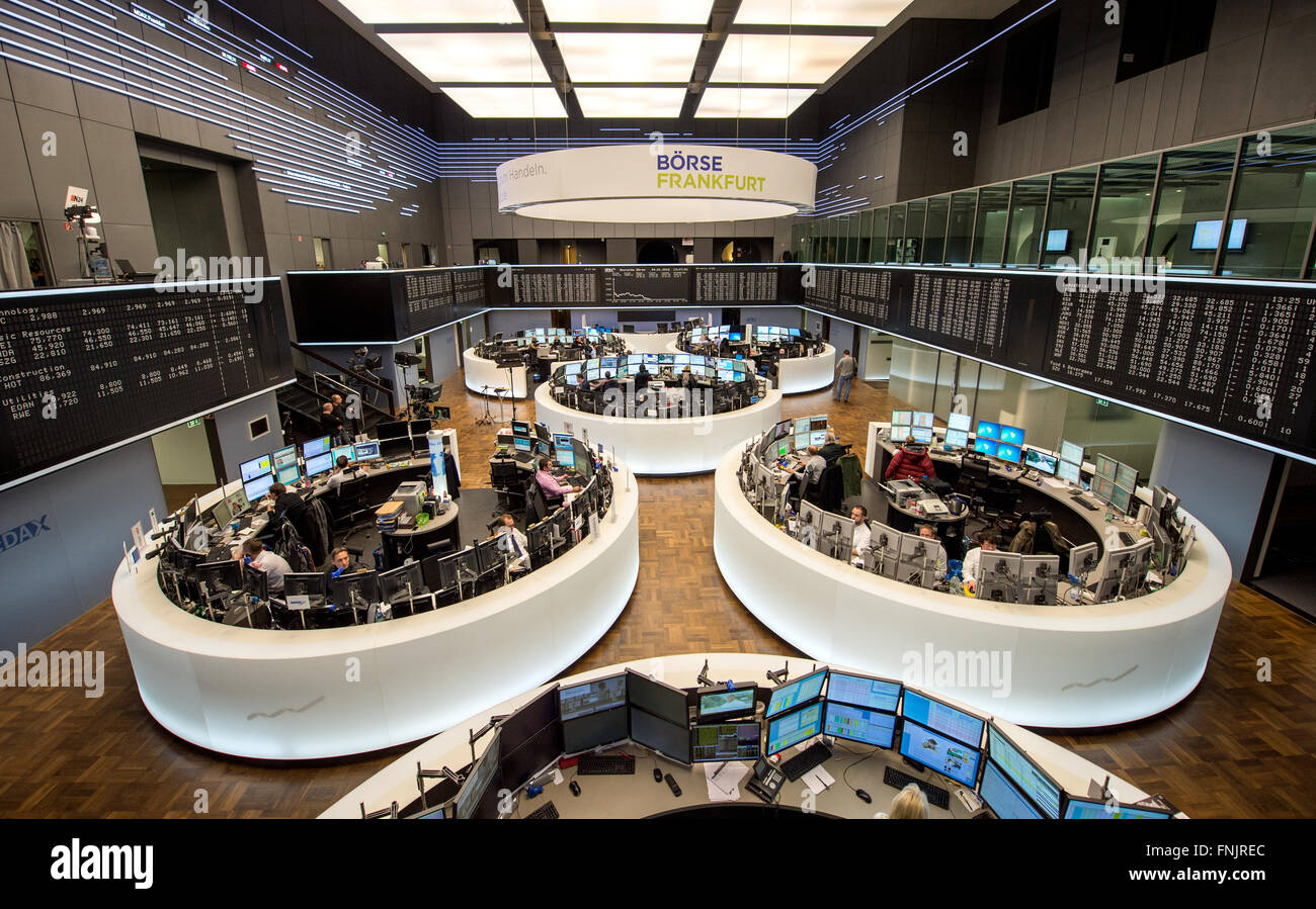Stock brokers sit in front of their monitors on the floor of the German ...