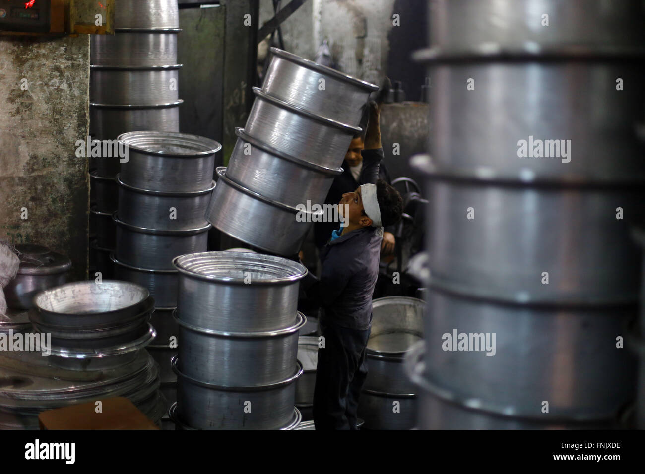 Cairo, Egypt. 13th Mar, 2016. An Egyptian worker makes aluminous ...