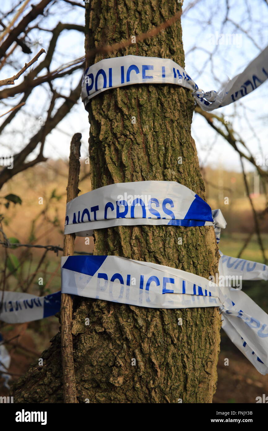 A 'don't cross' police line, at a crime scene, in the countryside in ...