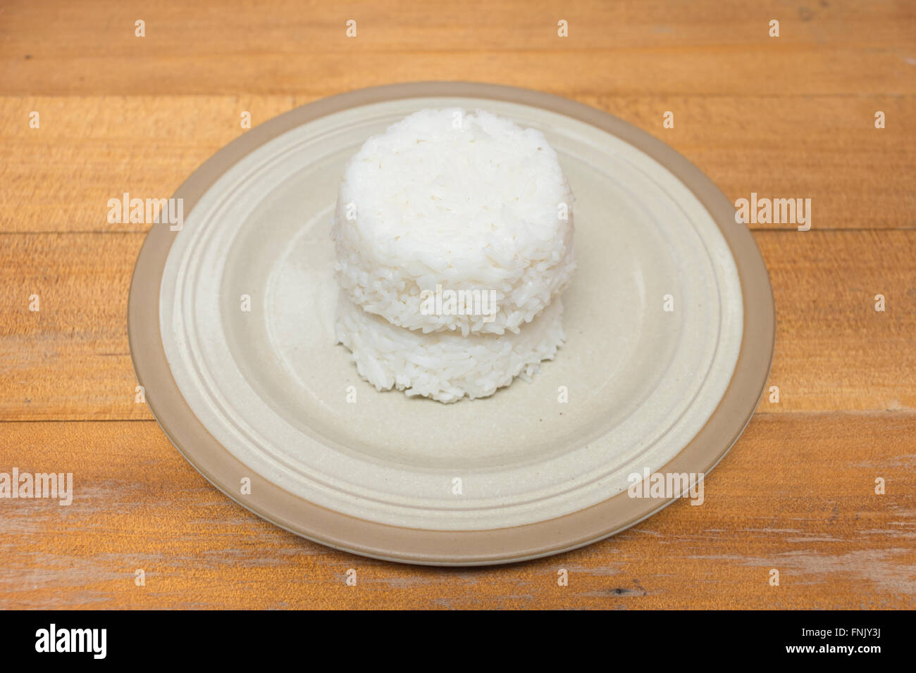 double cooked rice on a plate on wooden table Stock Photo - Alamy