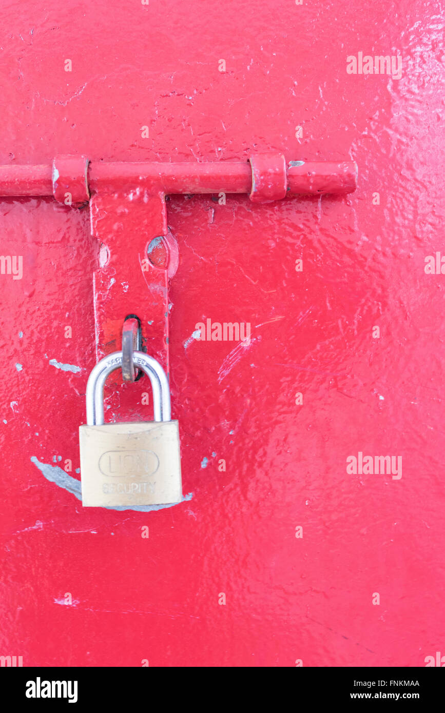 Red door with a lock locked Stock Photo - Alamy