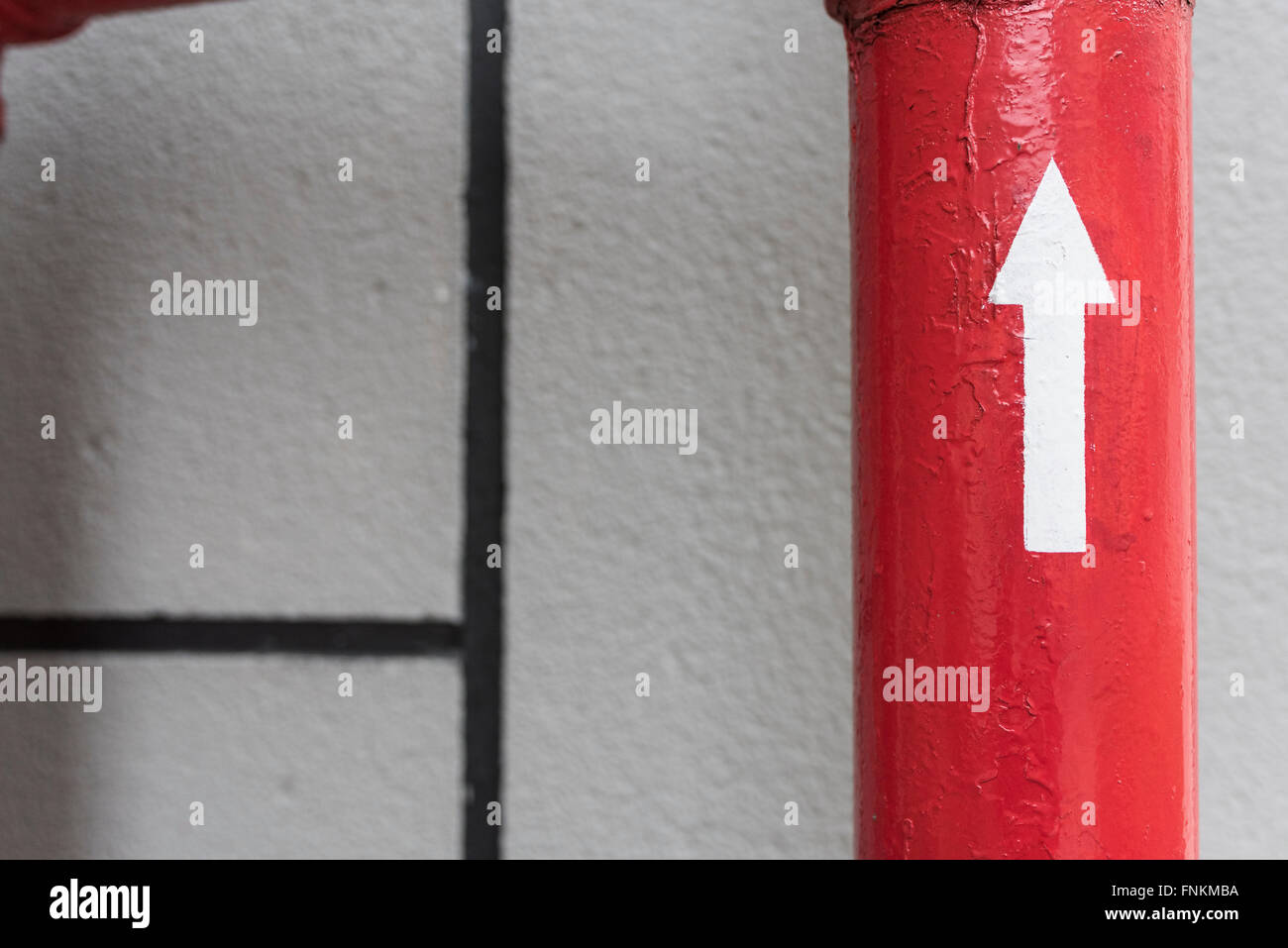 Red pipe have arrow on it and pointing direction Stock Photo - Alamy