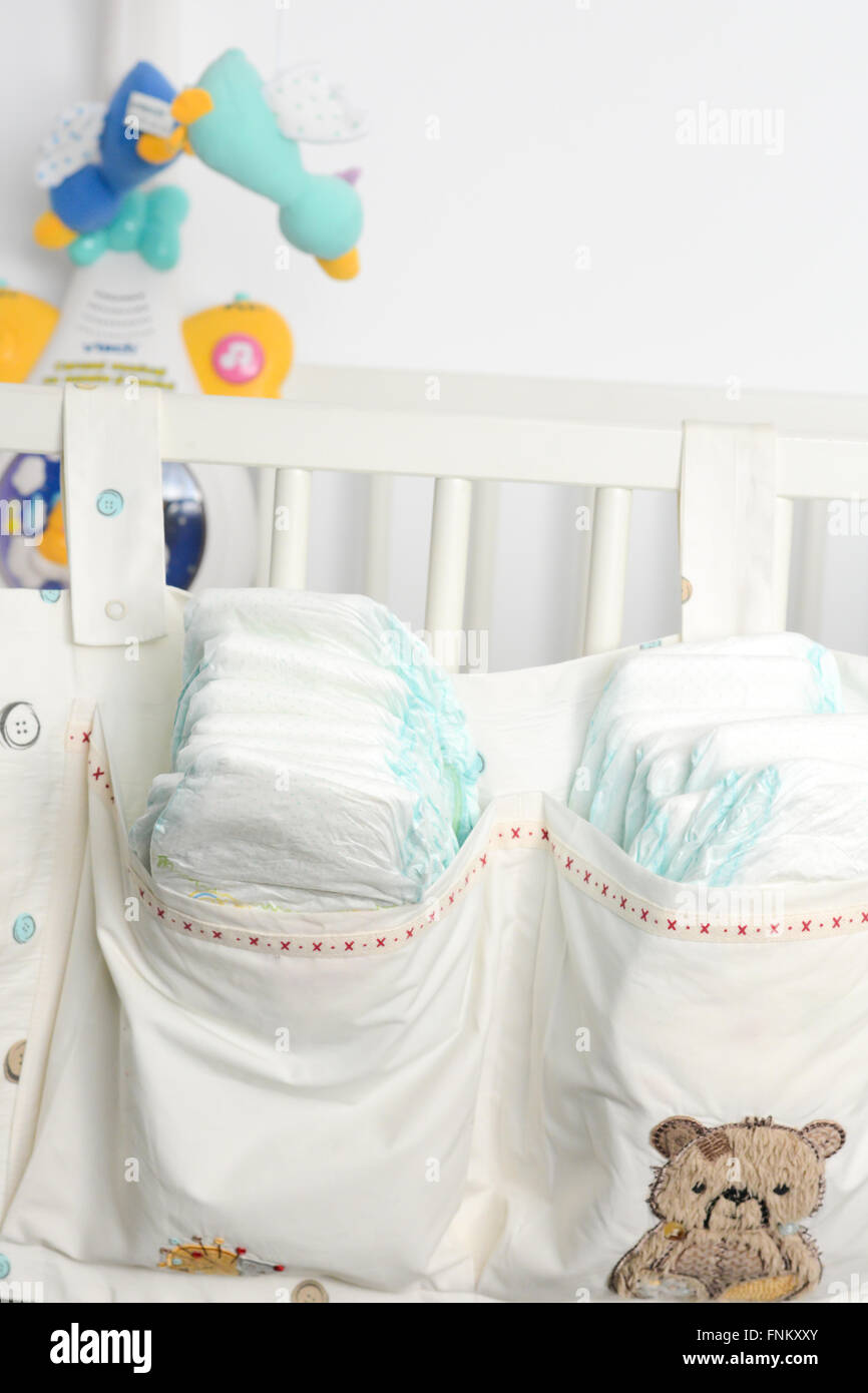 Pile or stack of diapers in baby bed hanging storage bag Stock Photo ...