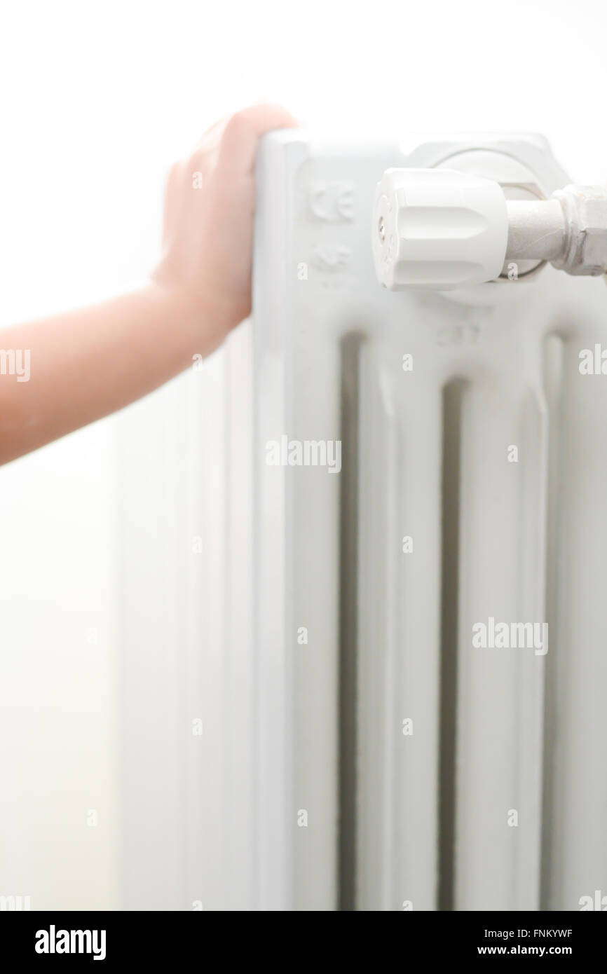 human hand touching Room radiator or heater Stock Photo - Alamy