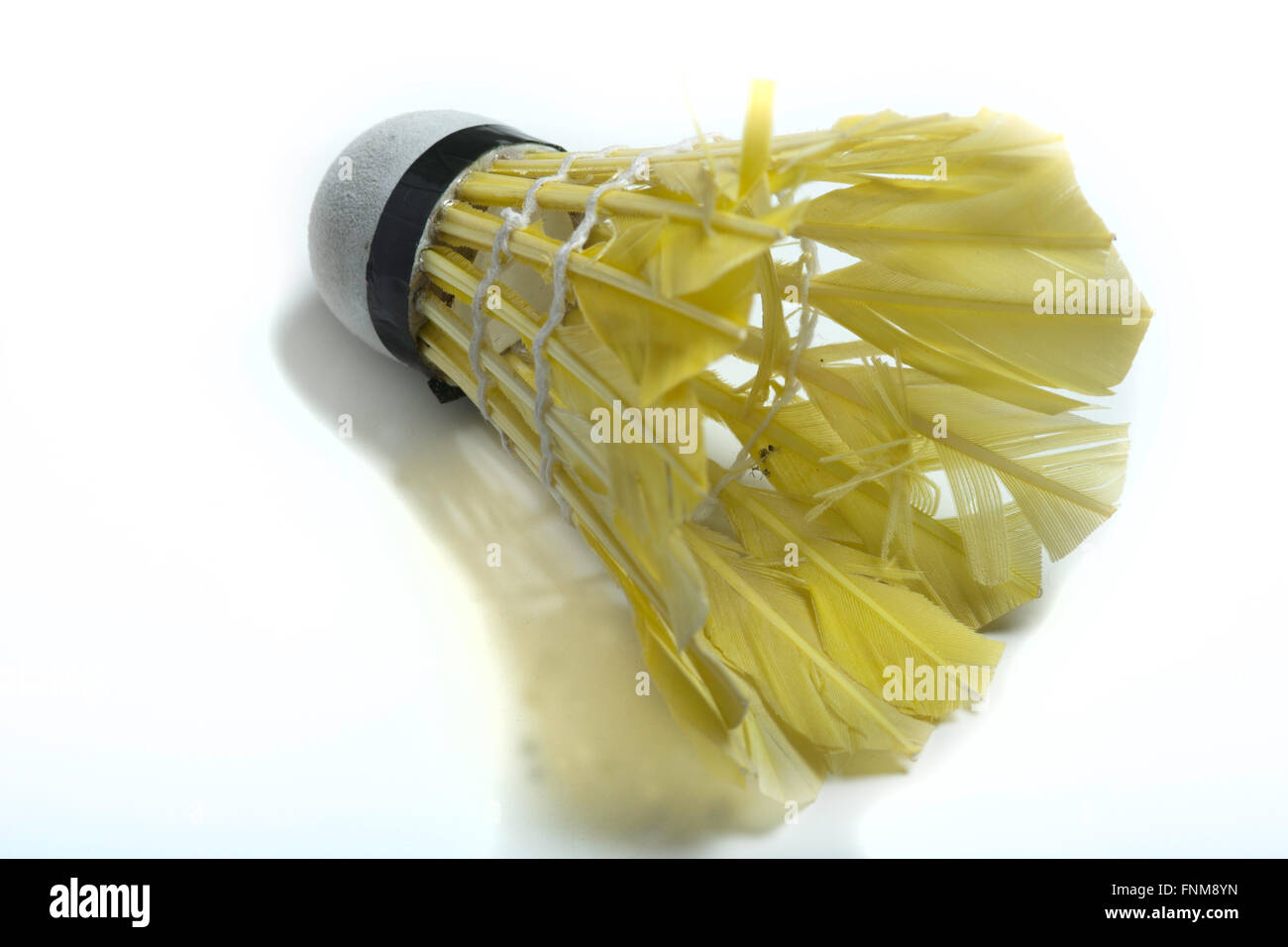 Yellow shuttlecock on white Stock Photo - Alamy