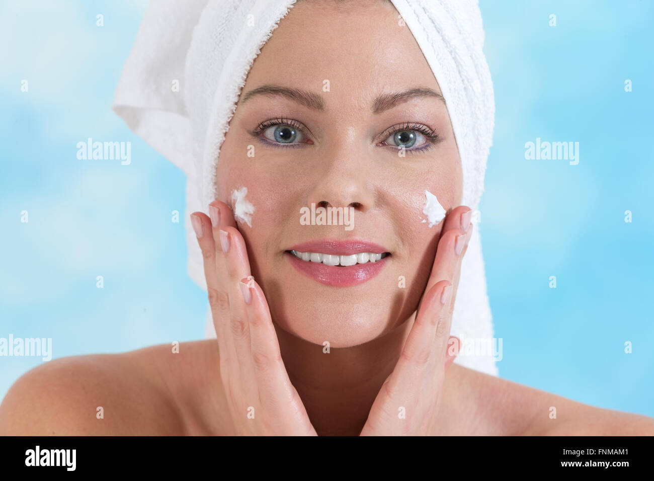 Beautiful woman face with moisturising cream Stock Photo - Alamy