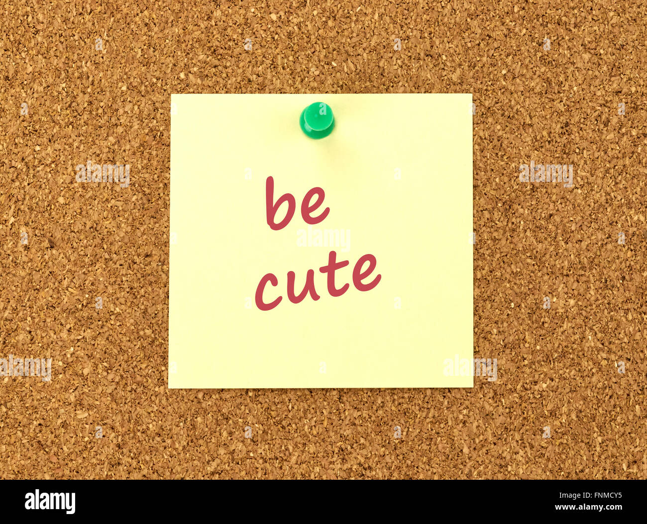 The phrase Be Cute in red text on a yellow sticky note posted to a cork ...