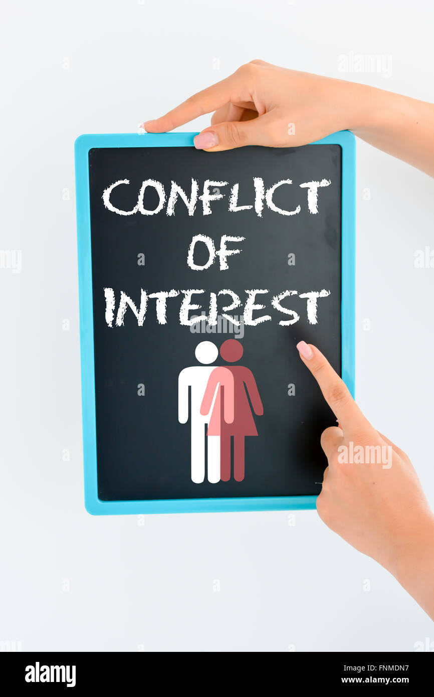 Conflict of interest concept on small blackboard Stock Photo - Alamy