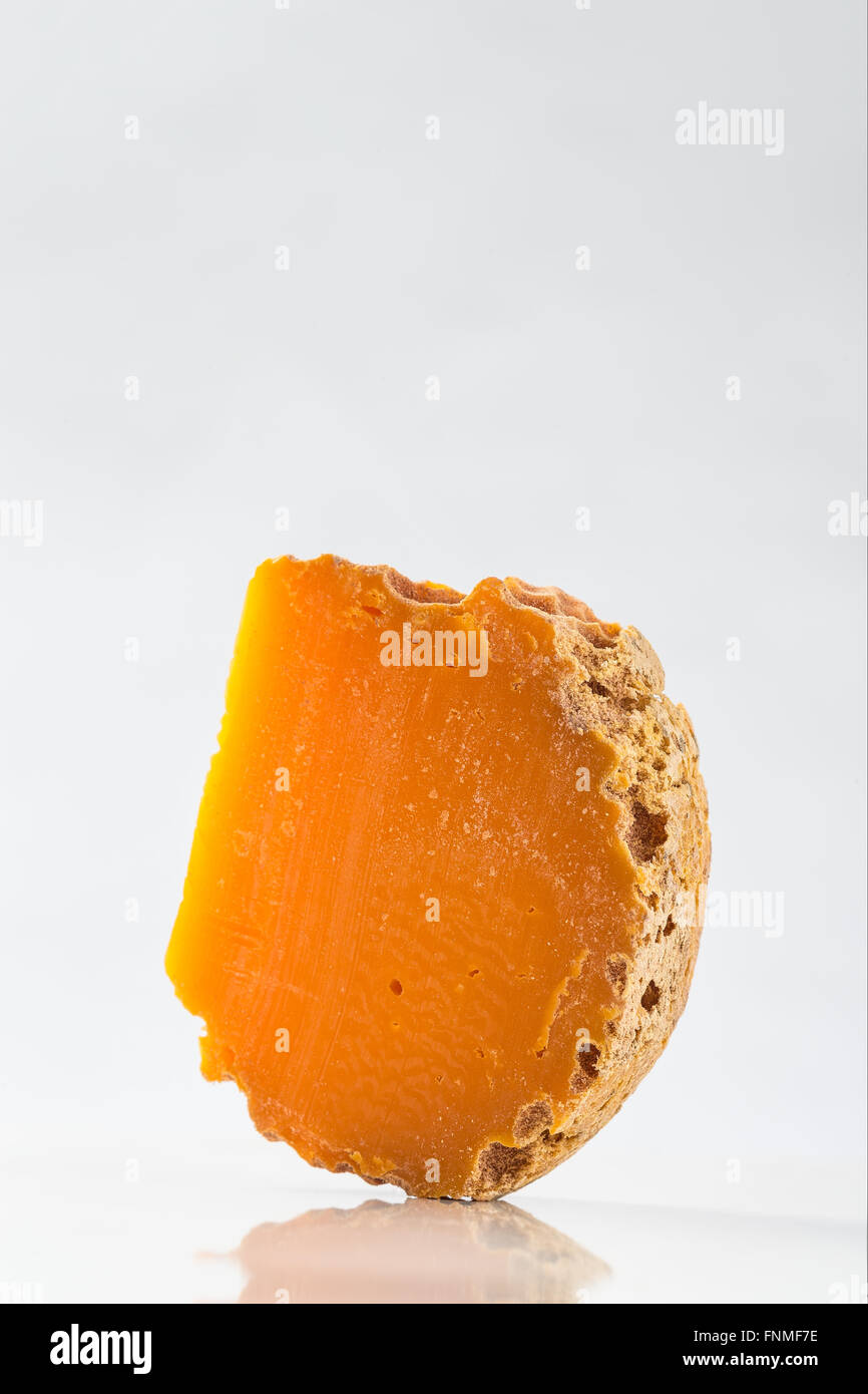 Portion of Mimolette Cheese isolated on white background Stock Photo ...