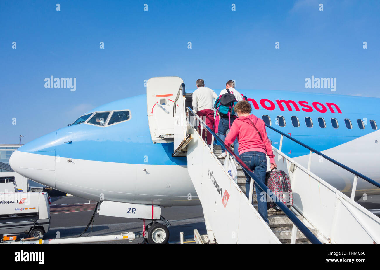 Passengers boarding Thomson flight at Newcastle airport. UK Stock Photo ...