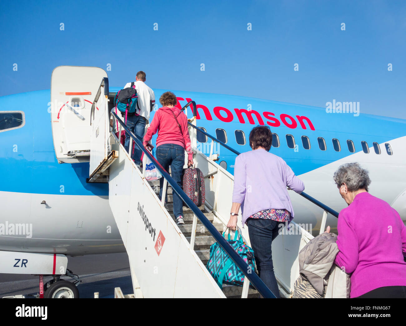 Passengers boarding Thomson flight at Newcastle airport. UK Stock Photo ...