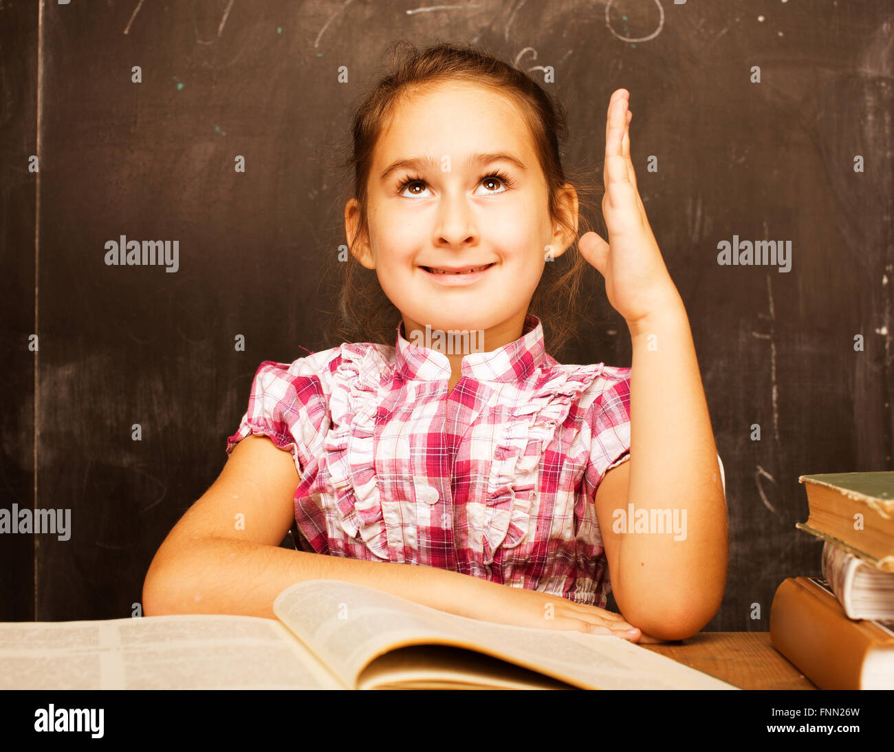 cute little real girl pupil in classroom at blackboard writting, girl ...