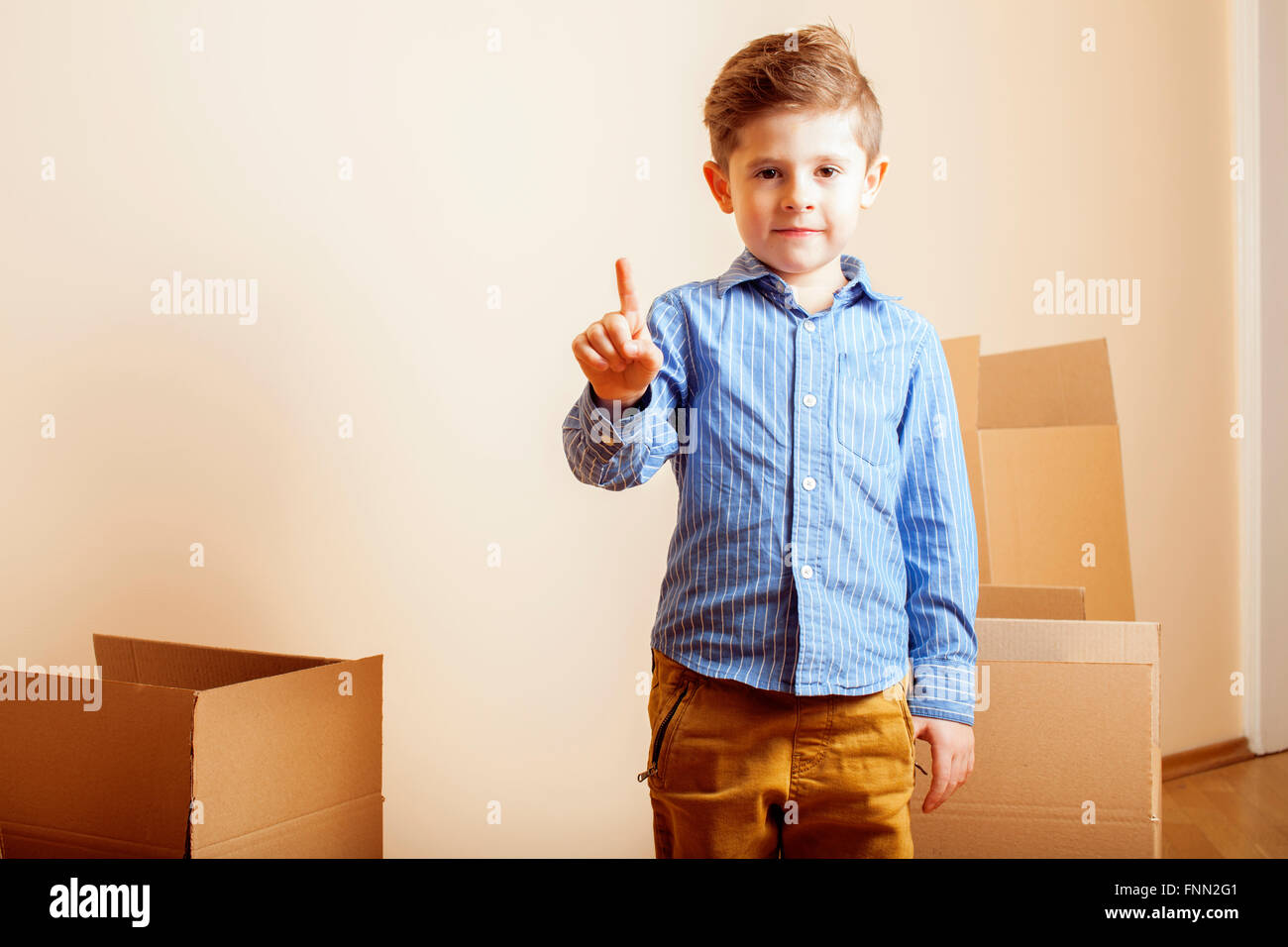 little cute boy in empty room, remoove to new house. home alone emong ...