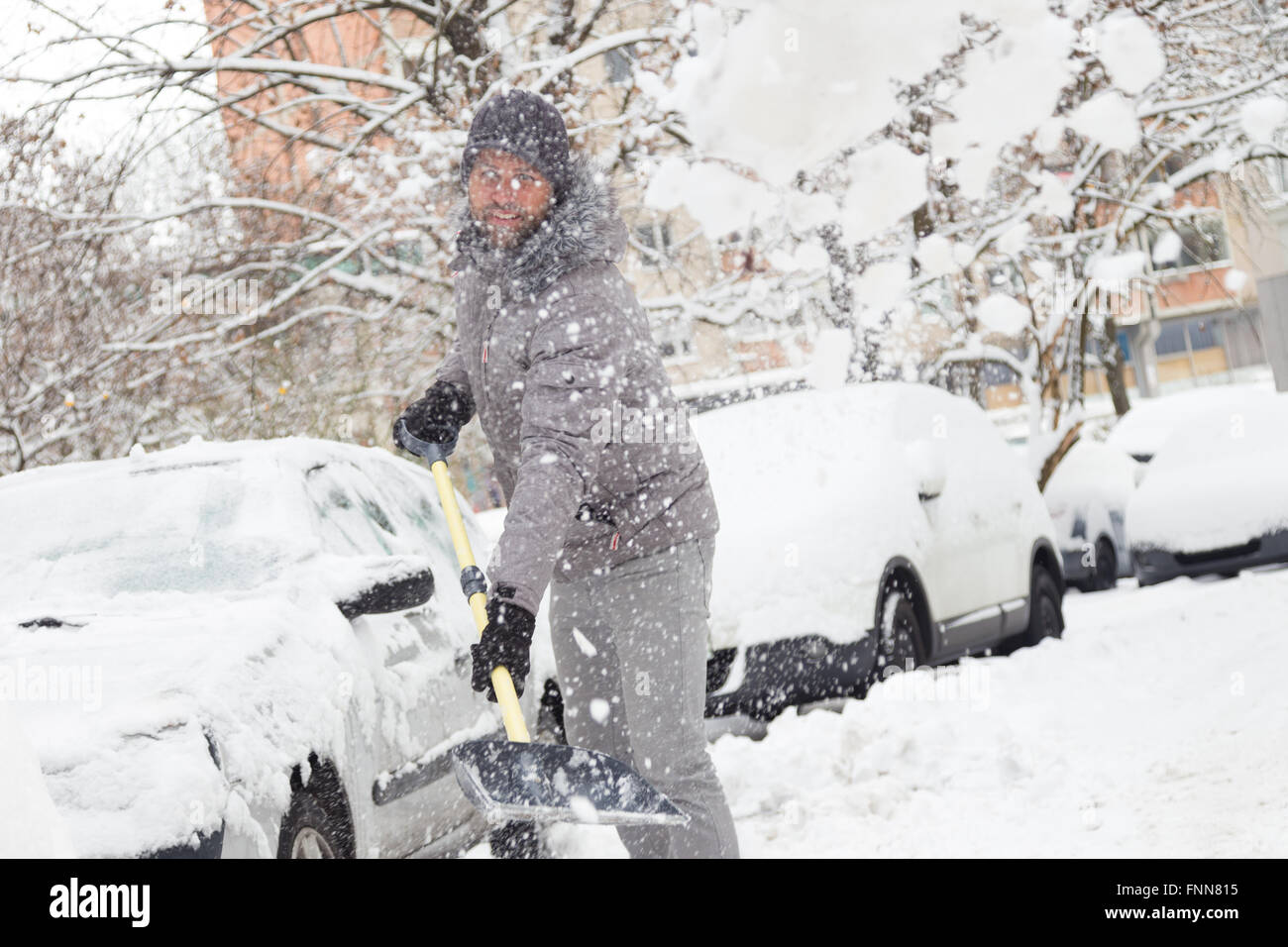 Man shoveling snow in winter Stock Photo - Alamy