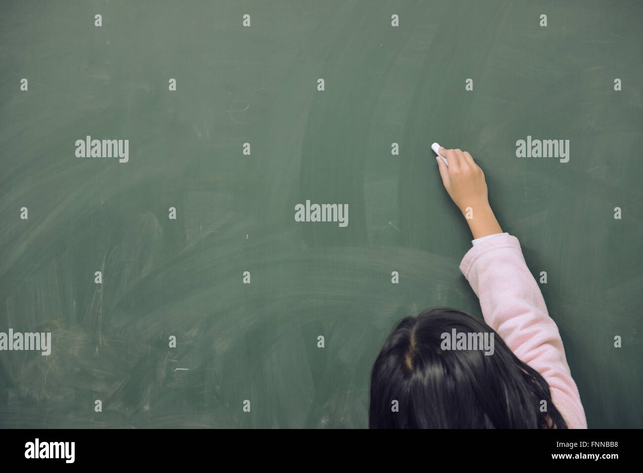 College student writing on blackboard hi-res stock photography and ...