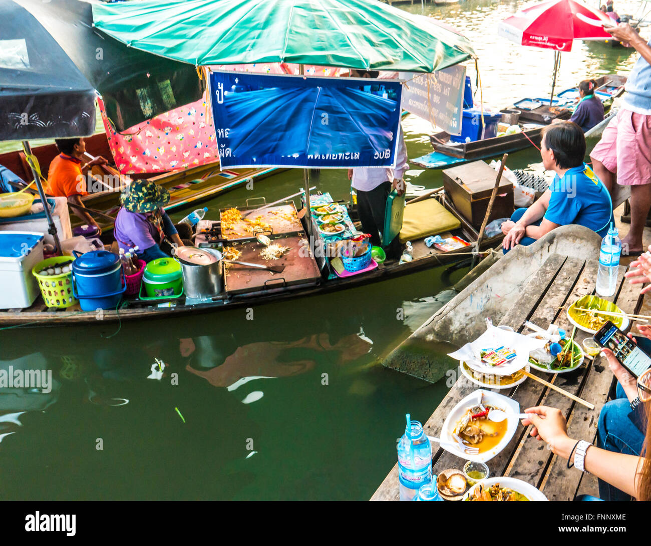 Trader's boats in a floating market in Thailand Stock Photo - Alamy