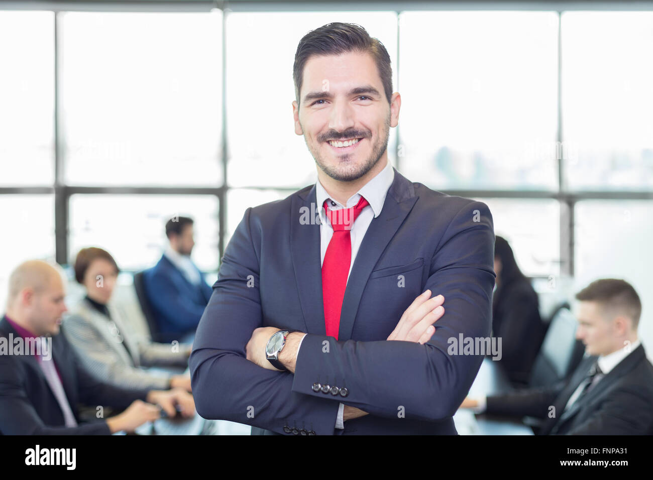 Team leader with coworkers working in office Stock Photo - Alamy