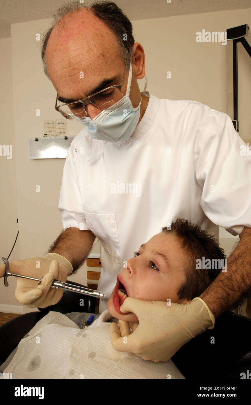 Young boy having his teeth checked and cleaned at the dentist Stock ...