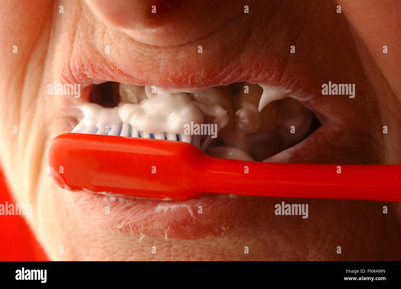 Facial close-up of a woman brushing her teeth Stock Photo - Alamy