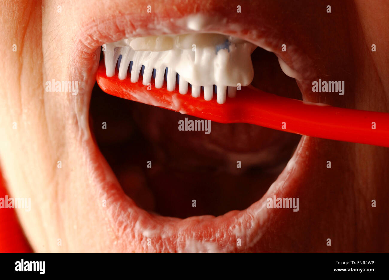 Facial close-up of a woman brushing her teeth Stock Photo - Alamy