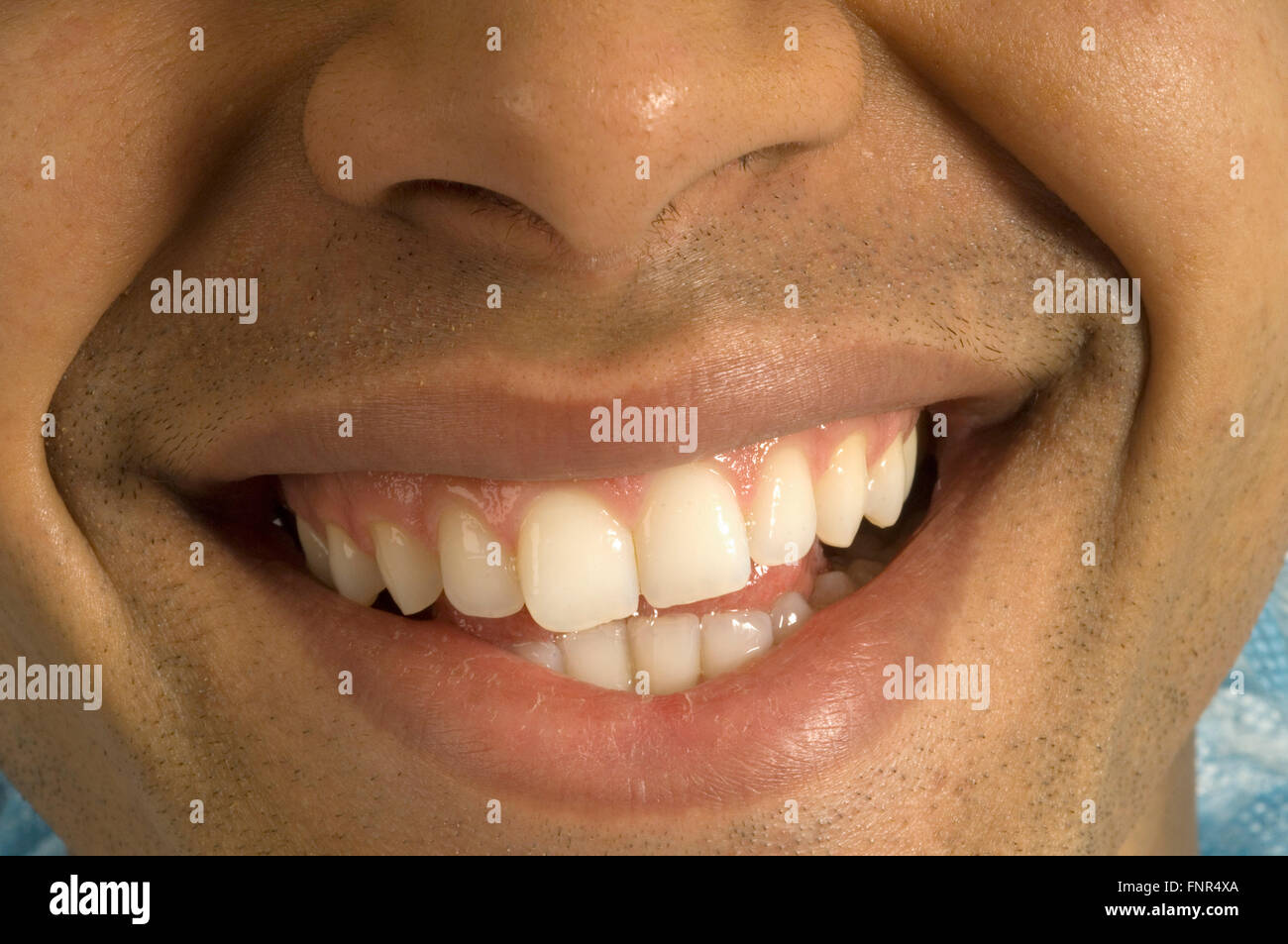 Close-up of a person smiling wide to show their teeth Stock Photo - Alamy
