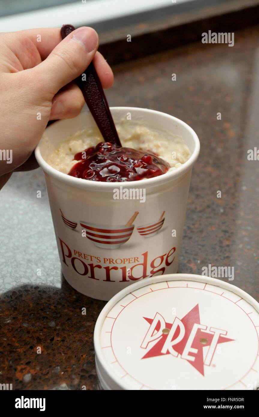 Pret a Manger Porridge being stirred with jam on top Stock Photo - Alamy
