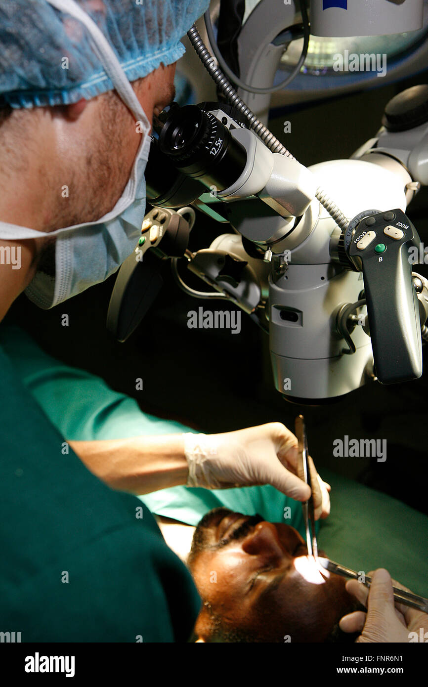 A surgeon uses a surgical microscope during plastic surgery Stock Photo ...