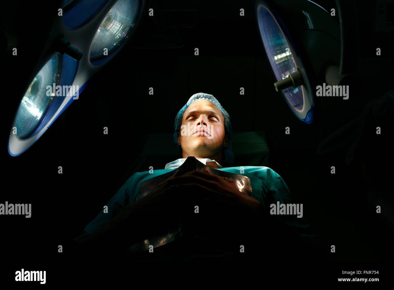 A tired surgeon lays asleep on an operating table Stock Photo - Alamy