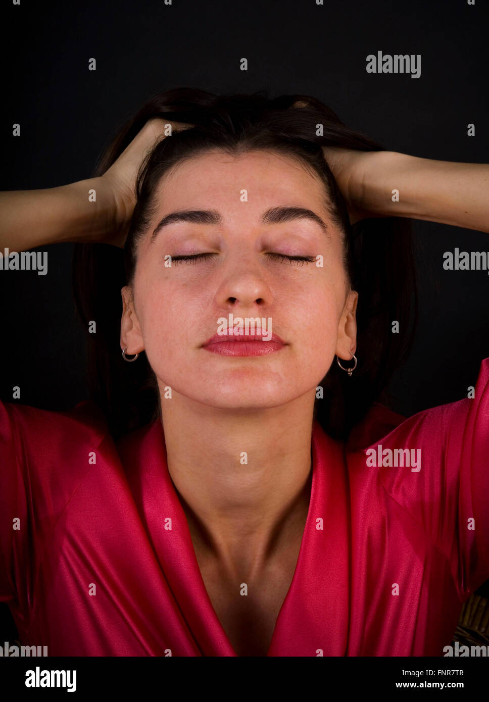 Woman running her hands through her hair Stock Photo - Alamy
