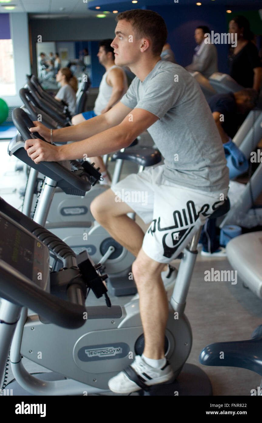 A man exercising on spinning cycles in a gym Stock Photo - Alamy