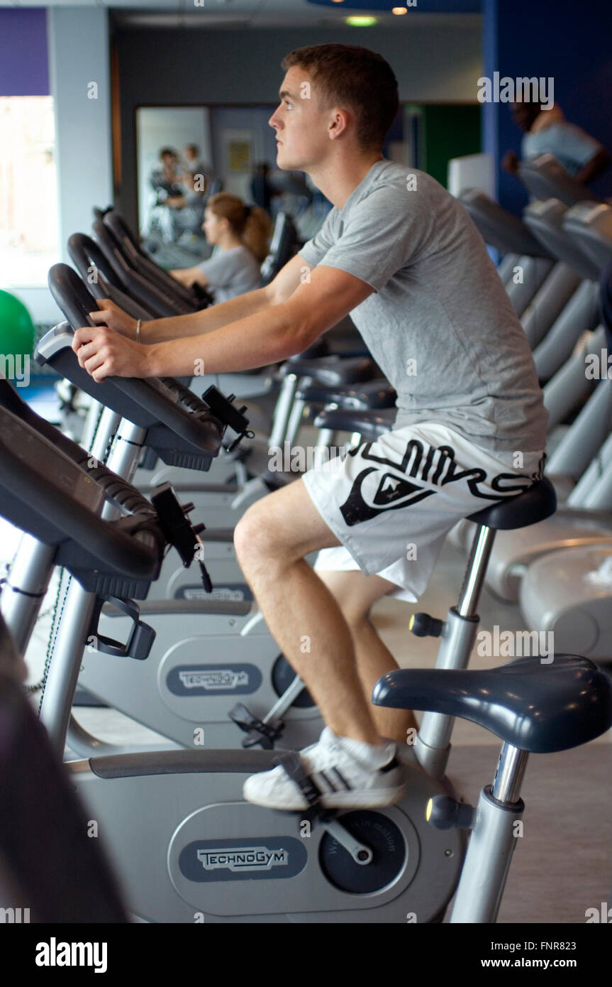 A man exercising on spinning cycles in a gym Stock Photo - Alamy