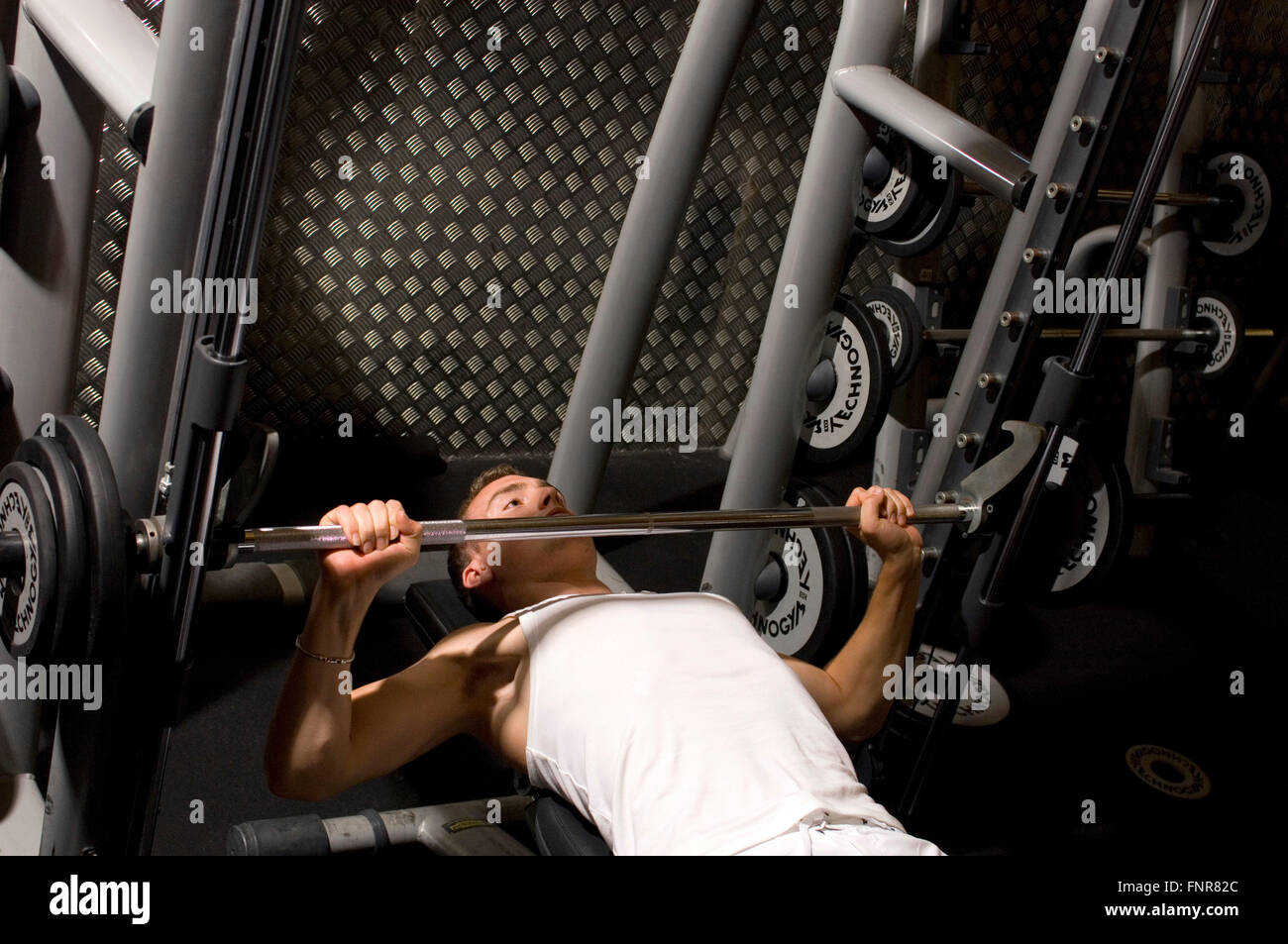 A man exercising by using gym equipment Stock Photo - Alamy