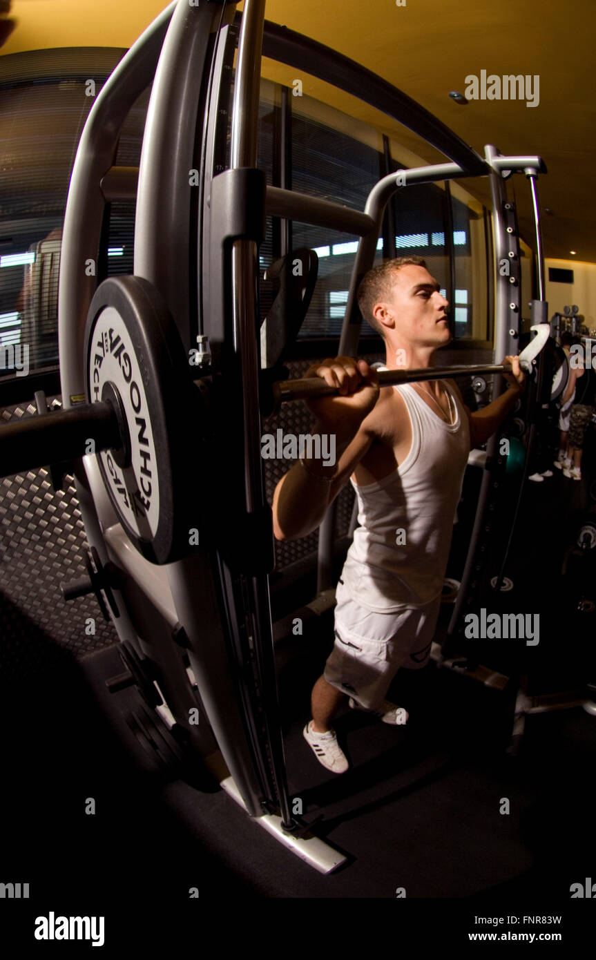 A man exercising by using gym equipment Stock Photo - Alamy
