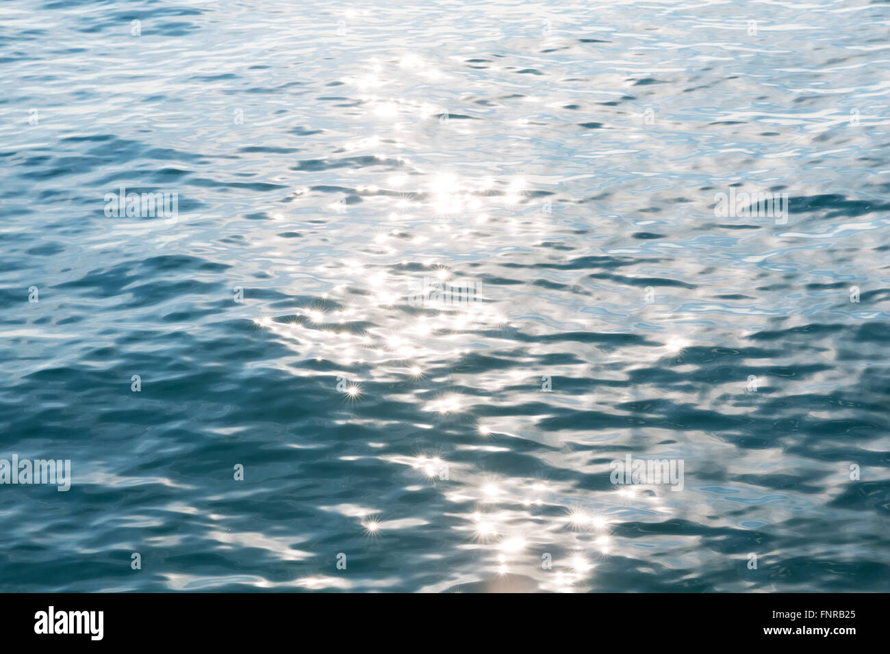 Sun reflection on blue sea water Stock Photo - Alamy