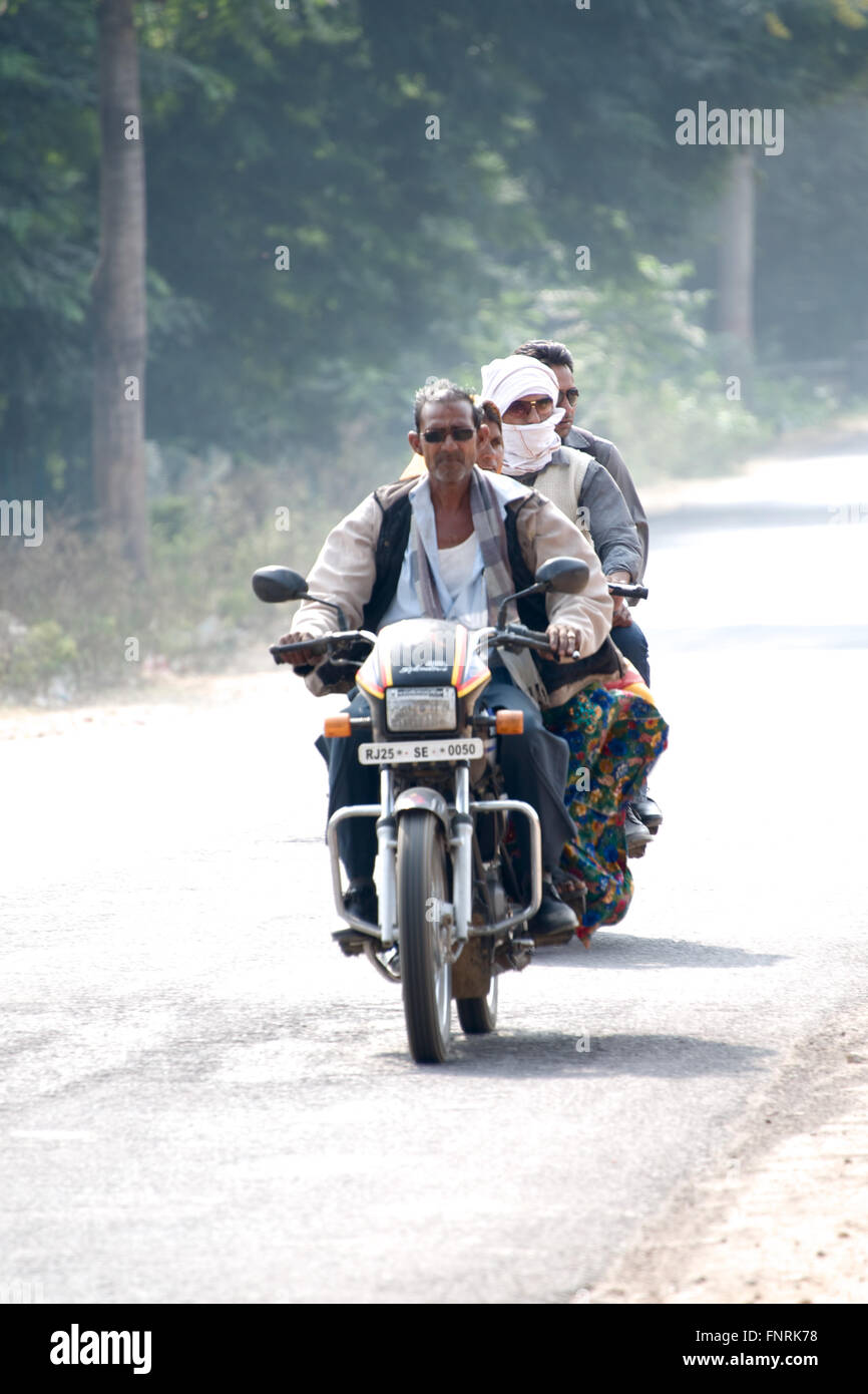 Four people on a motorbike Stock Photo - Alamy