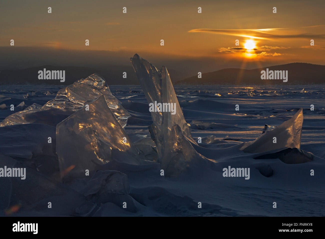 Transparent pieces of ice and the rising sun Stock Photo - Alamy