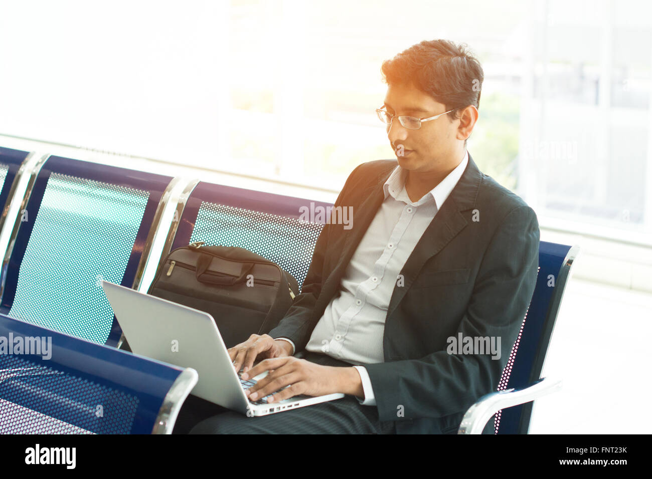 Asian Indian businessman using laptop computer Stock Photo - Alamy