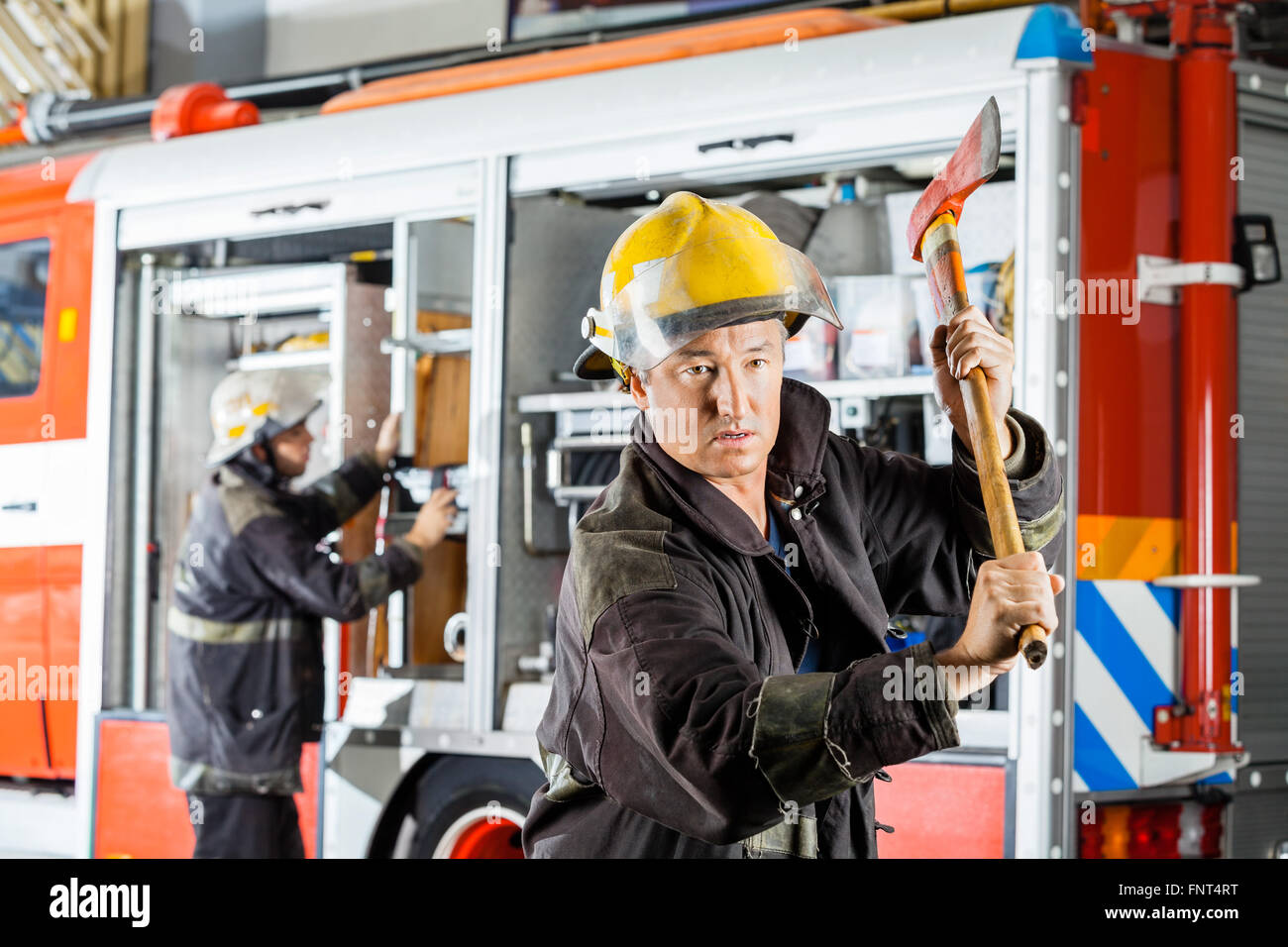 Firefighter holding axe hi-res stock photography and images - Alamy